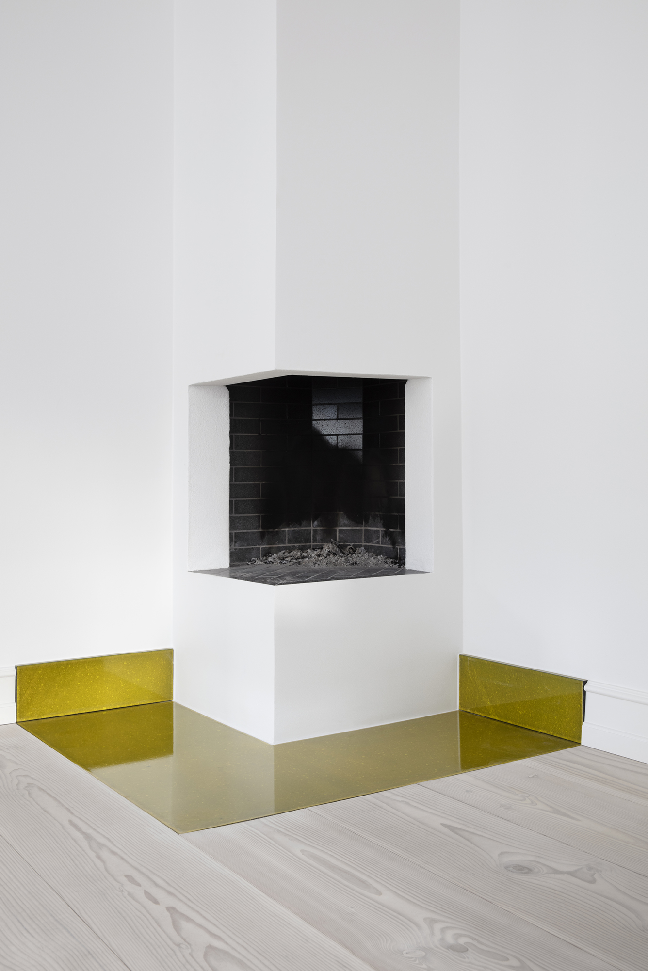 Mustard yellow and dark grey lava stone fireplace - Made a Mano