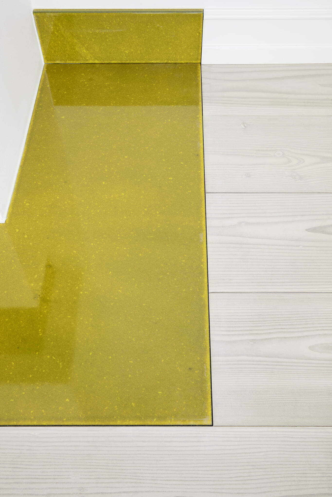 Mustard yellow and dark grey lava stone fireplace - By Made a Mano.